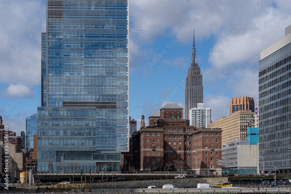 Empire state building shot from a ferry on the hudson river sticking ...