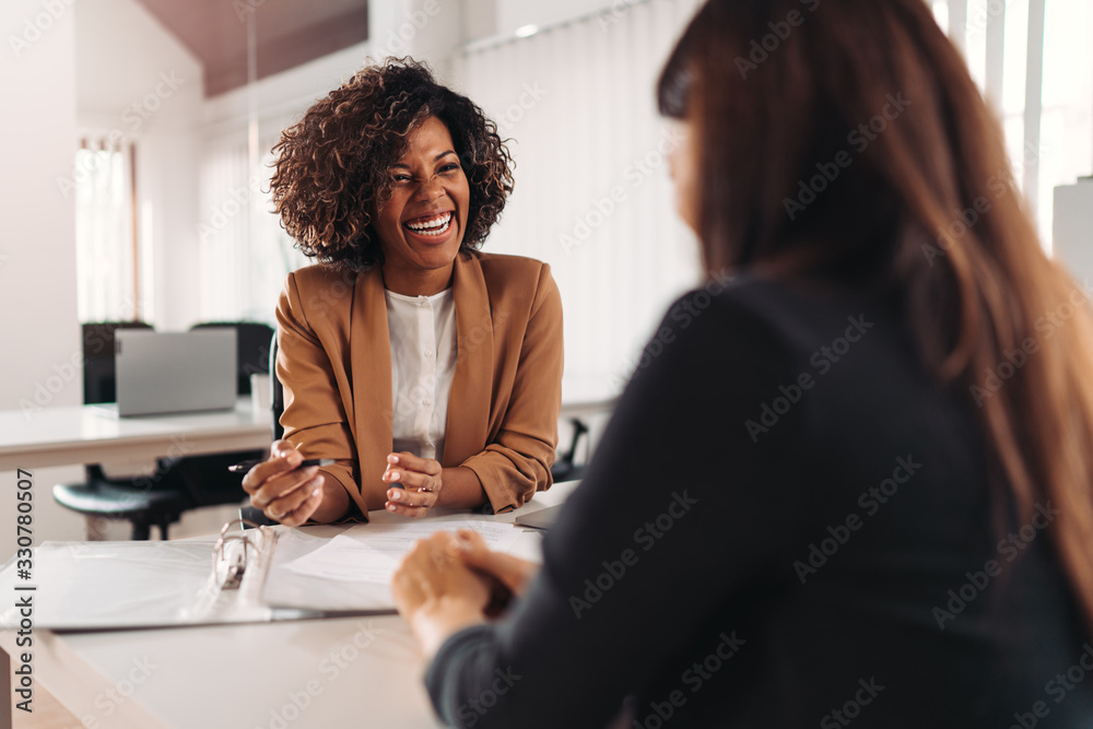 Female financial advisor consulting a client Stock Photo | Adobe Stock