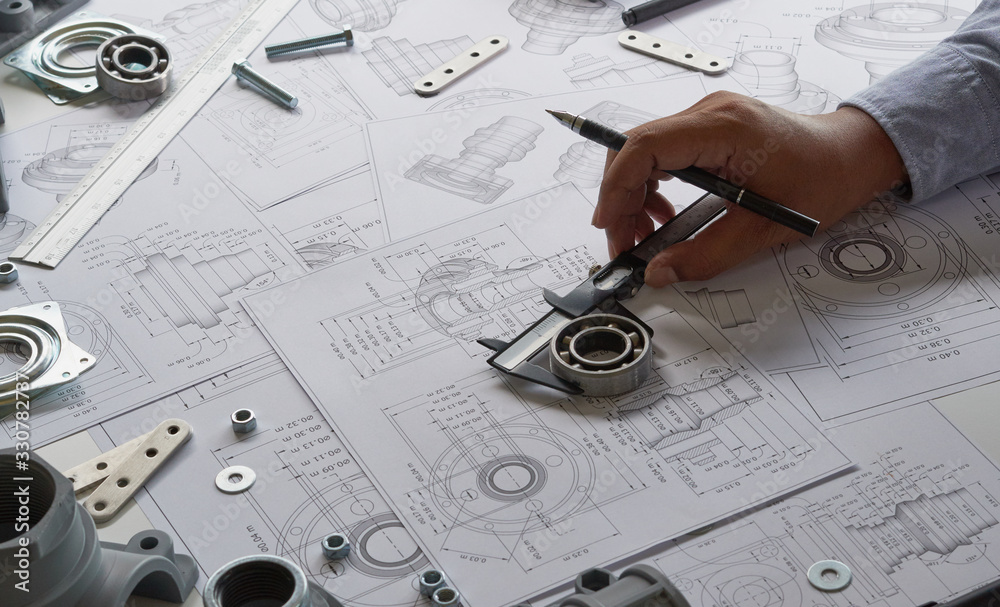Engineer technician designing drawings mechanical parts engineering ...