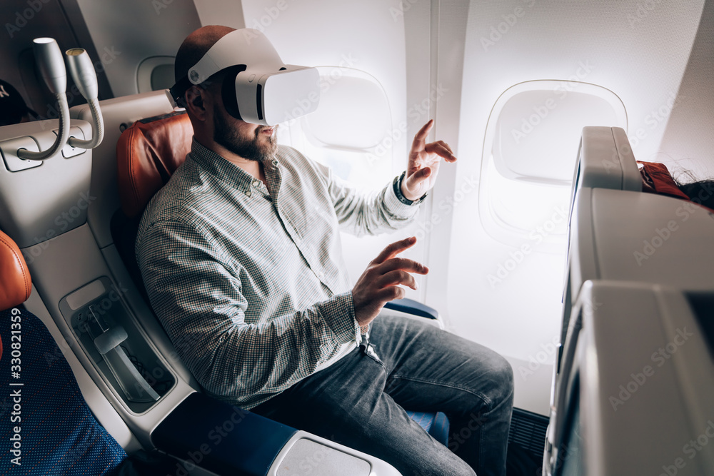 Millennial man touching haptic dimension during virtual projection for ...