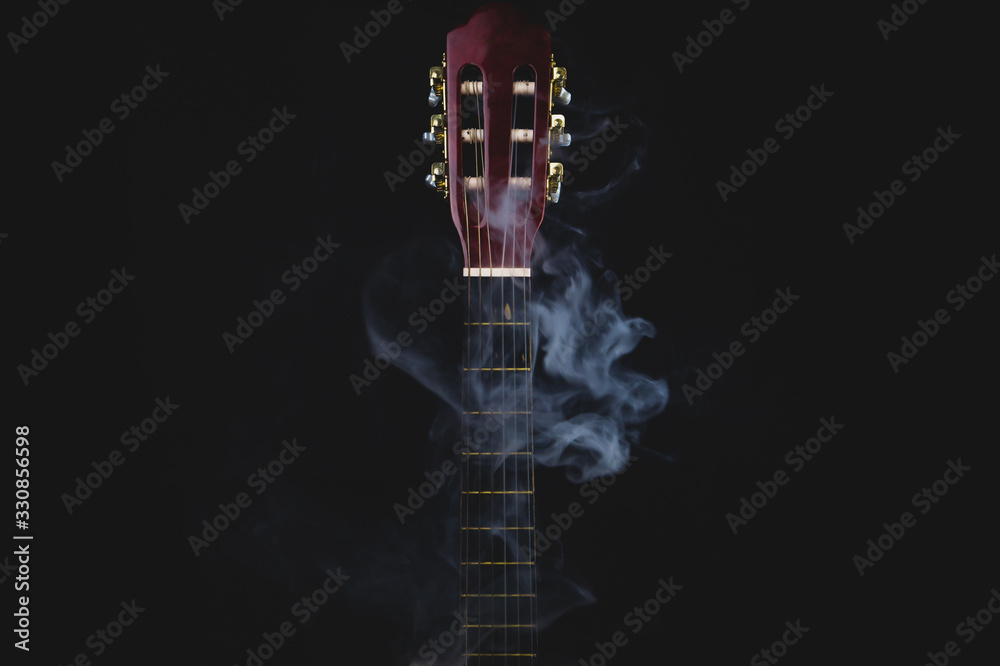 Acoustic guitar in smoke on the black background. musical instrument ...