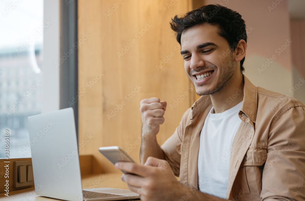 Young handsome Indian man holding mobile phone, communication, receive ...