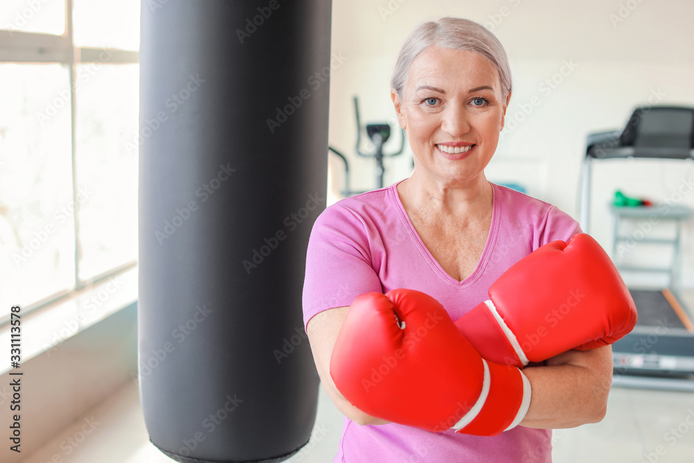 Sporty mature female boxer in gym Stock Photo | Adobe Stock