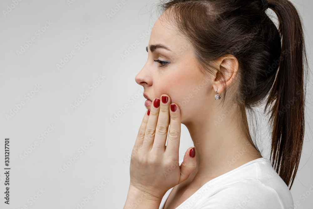 young sad woman suffering from tooth pain, caries. girl having ...