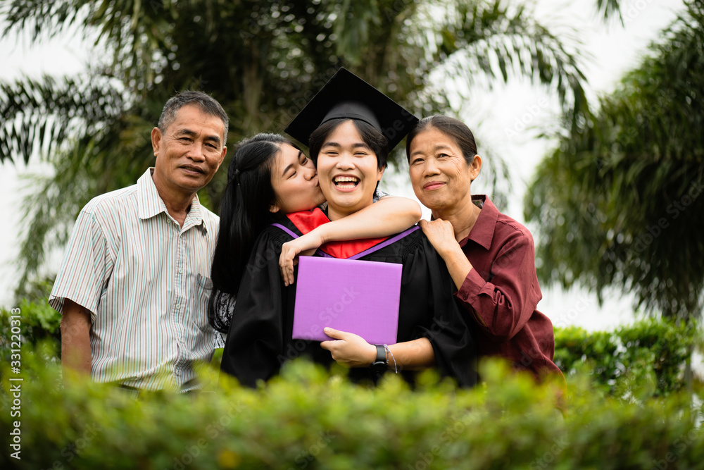 Graduation ceremony. Parents and family congratulate the student, who ...
