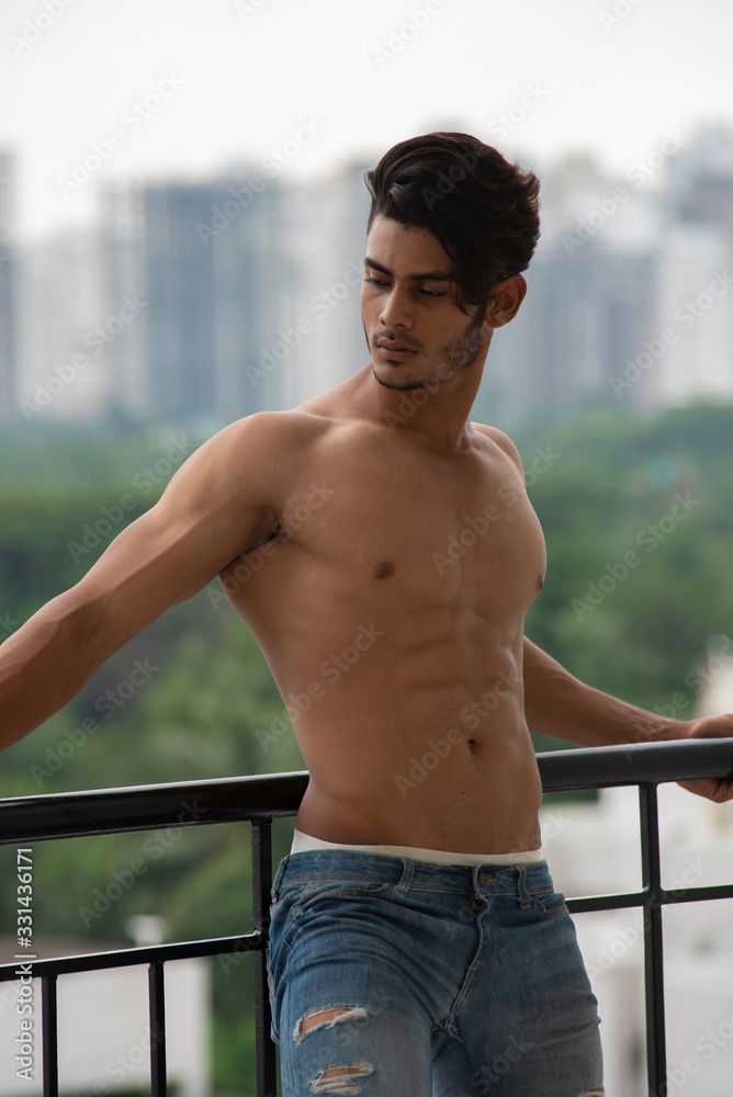 Portrait of an young and handsome brunette Bengali muscular man ...