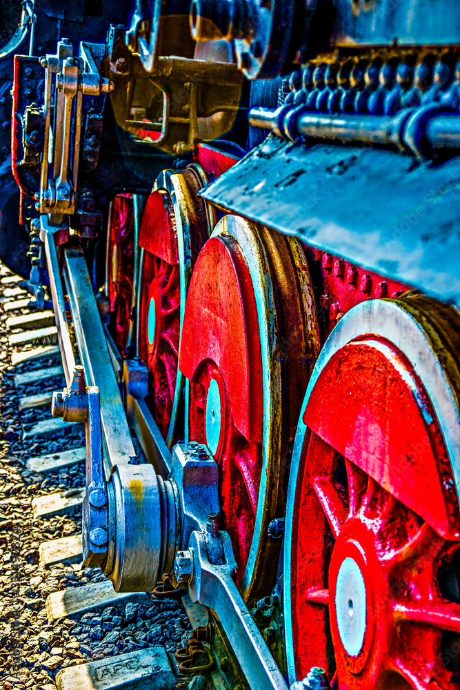 Red driving wheels of a vintage steam engine locomotive. Driving rods ...