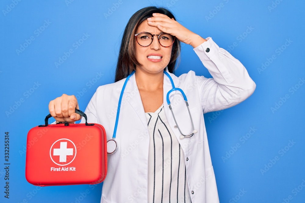 Young doctor woman holding medical first aid kit red box for emergency ...
