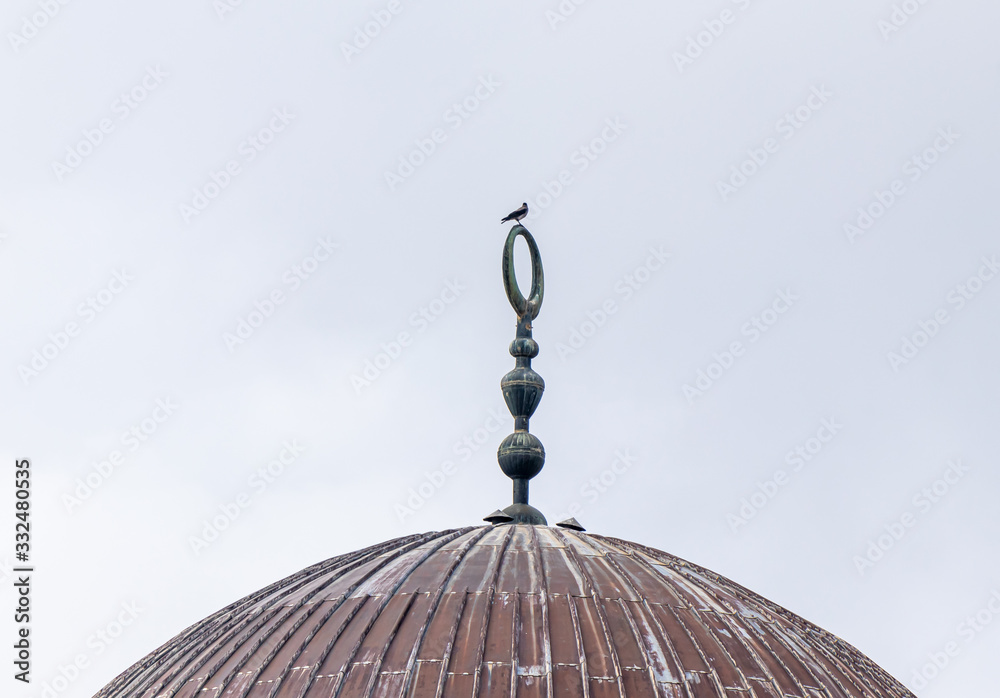 A crow sits on a Muslim symbol at the top of Al Aqsa Mosque on the ...