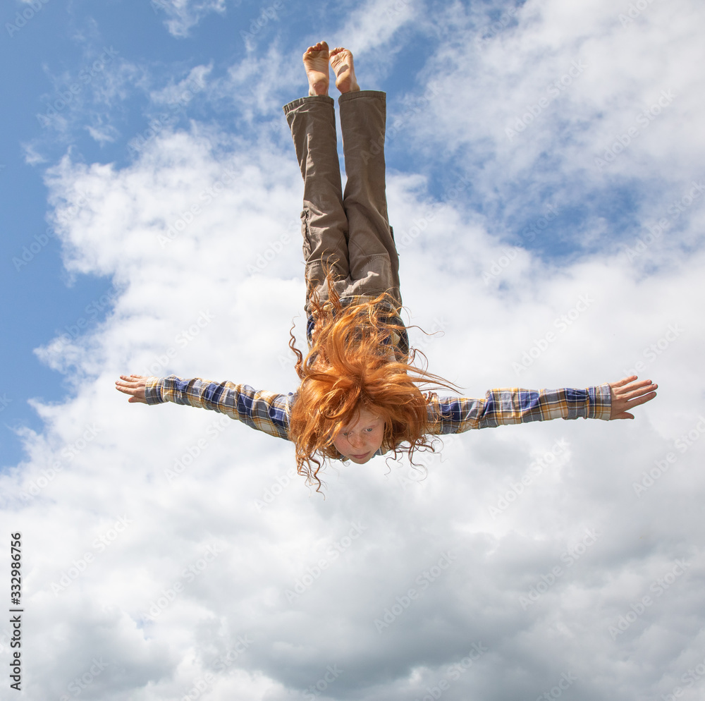 Young boy flying in the air Stock Photo | Adobe Stock