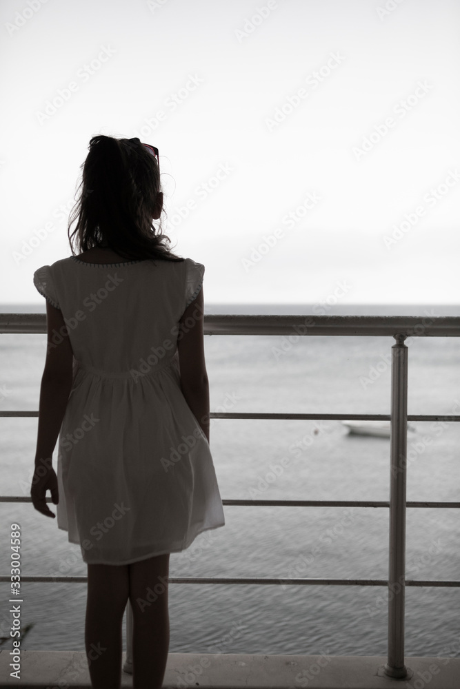 Little girl looking out balcony Stock Photo | Adobe Stock