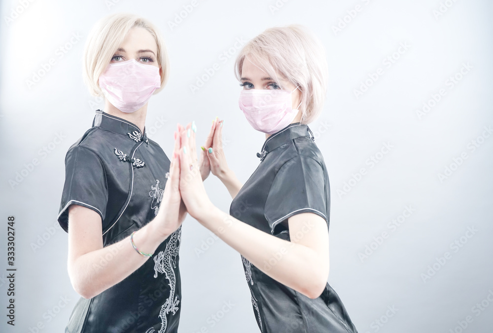 two European-looking women are dressed in black Chinese dresses and ...