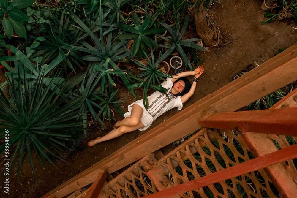beautiful sexy girl multicolored dreadlocks in white dress lies on ...