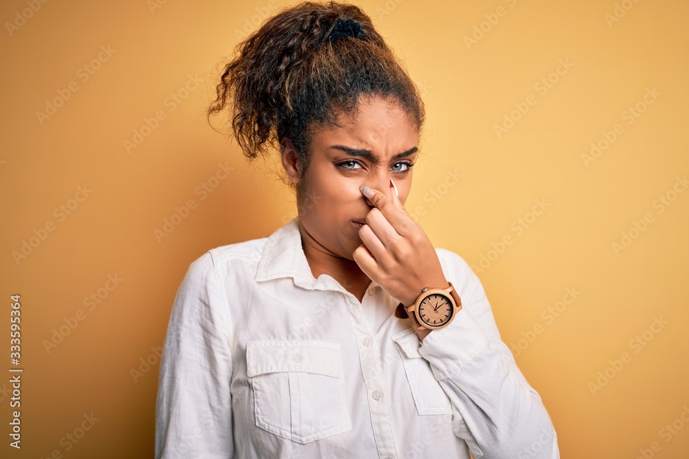 Young Beautiful African American Girl Wearing Casual Shirt Standing Over Yellow Background