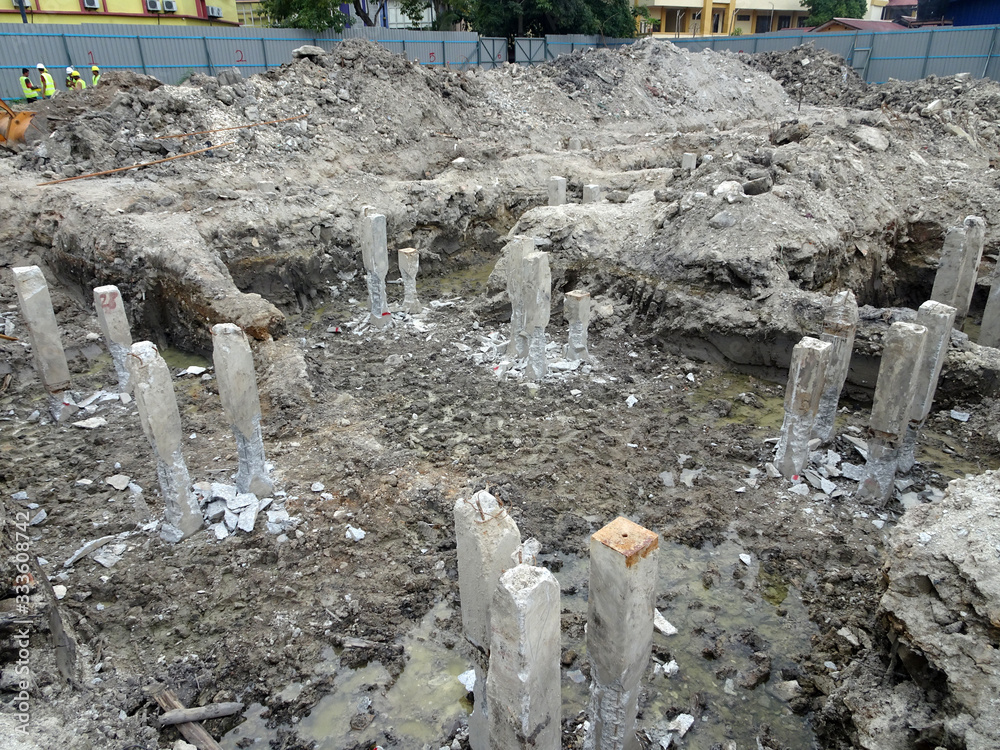 Square precast concrete pile at the construction site. Driven to soil ...