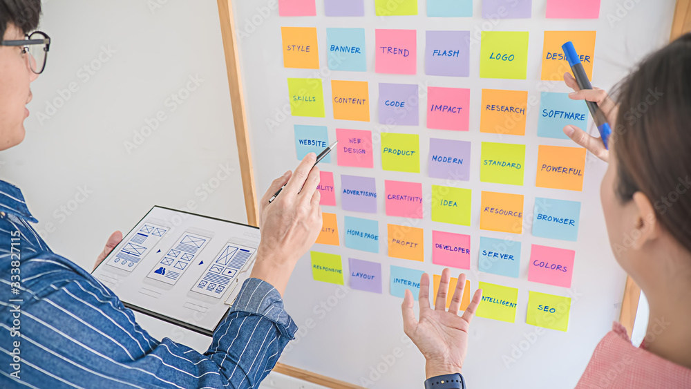 Web designer brainstorming for a strategy plan. Colorful sticky notes ...