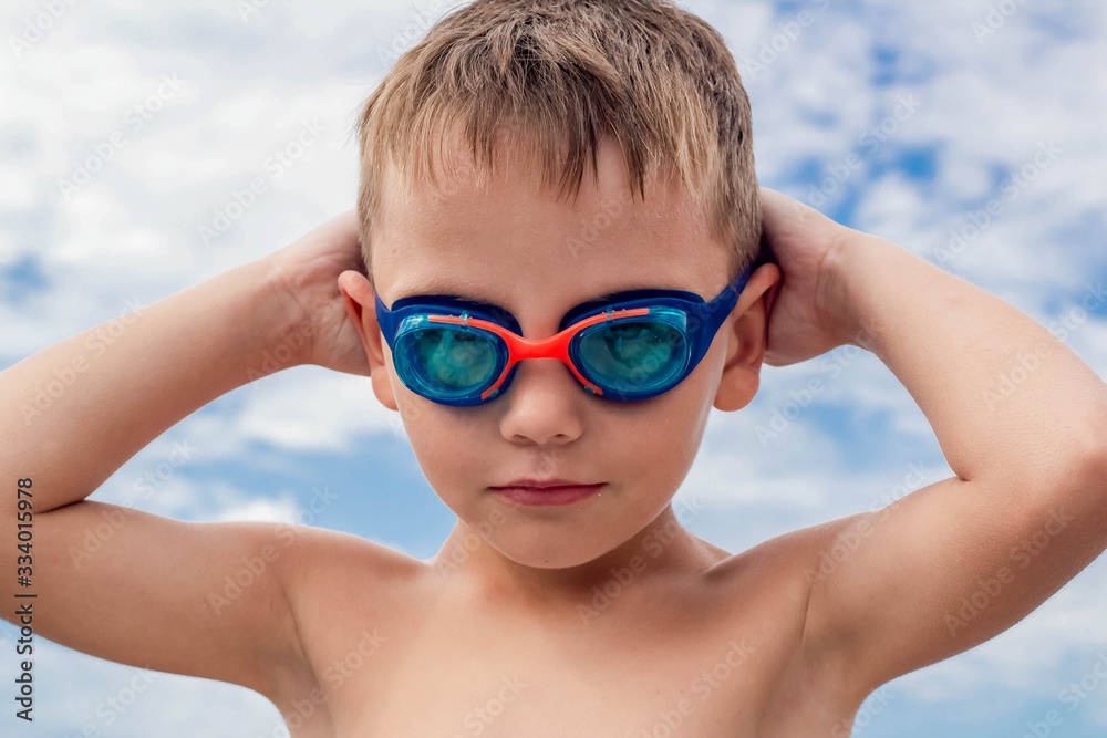 The boy is a swimmer. Sun, summer, vacation, joy. Purposeful, ready to ...