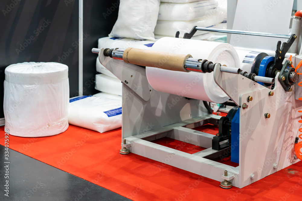 Raw material plastic roll set on auto feed shaft support of high ...