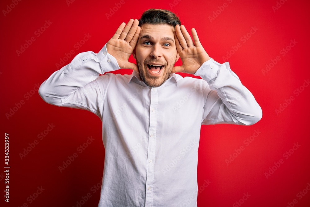Young business man with blue eyes wearing elegant shirt standing over ...