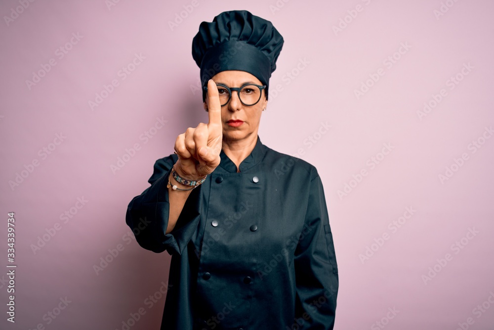 Middle age brunette chef woman wearing cooker uniform and hat over ...