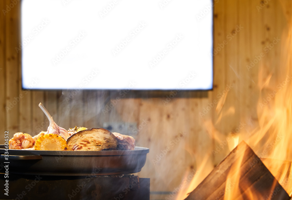 Big plate with vegetables lies on a pan, garlic, sweet pepper, potatoes ...