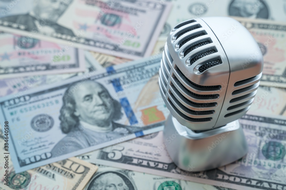 Retro chrome microphone on US dollar banknotes bill background with ...