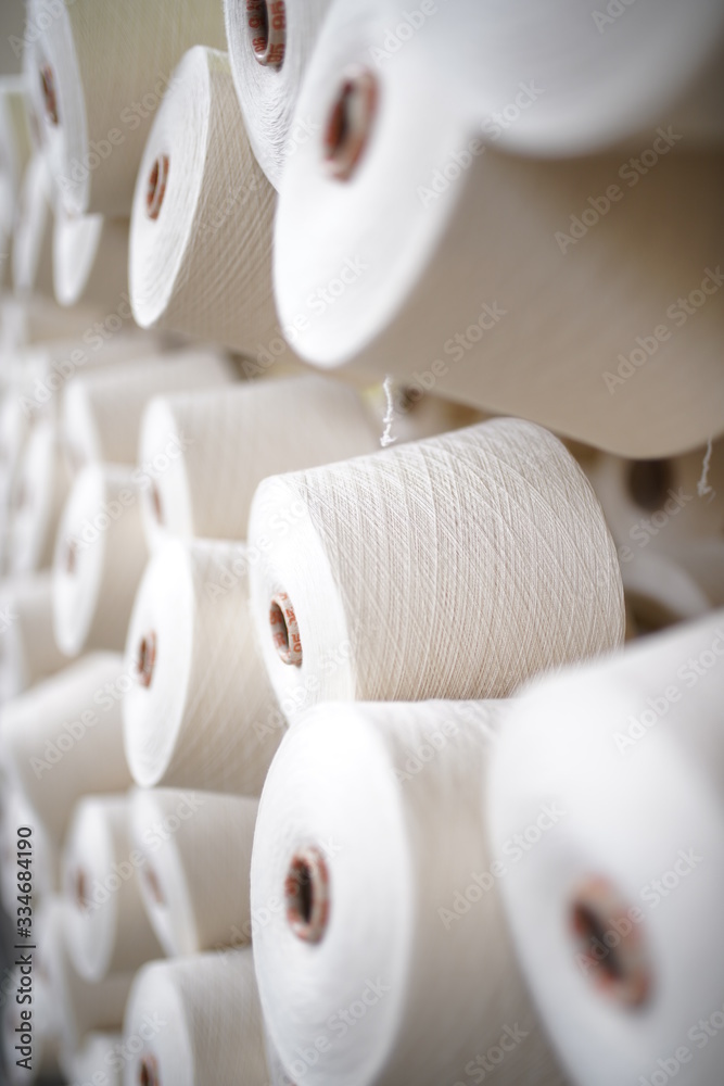 inside a textile factory, detailed image of yarn production and fabric ...