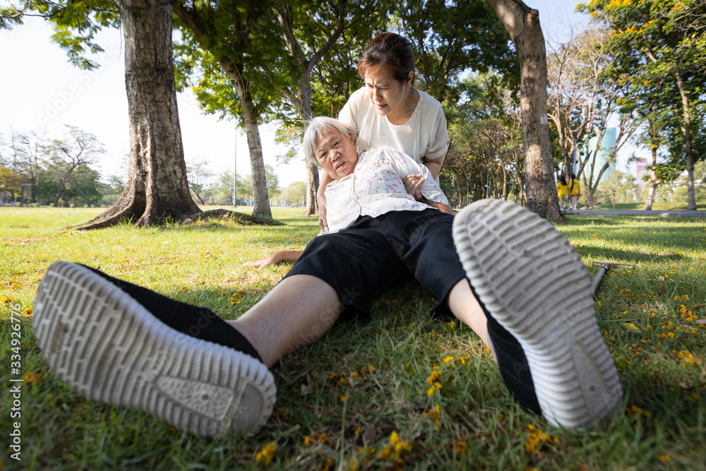 Tired exhausted senior woman lying on the floor after falling down from ...