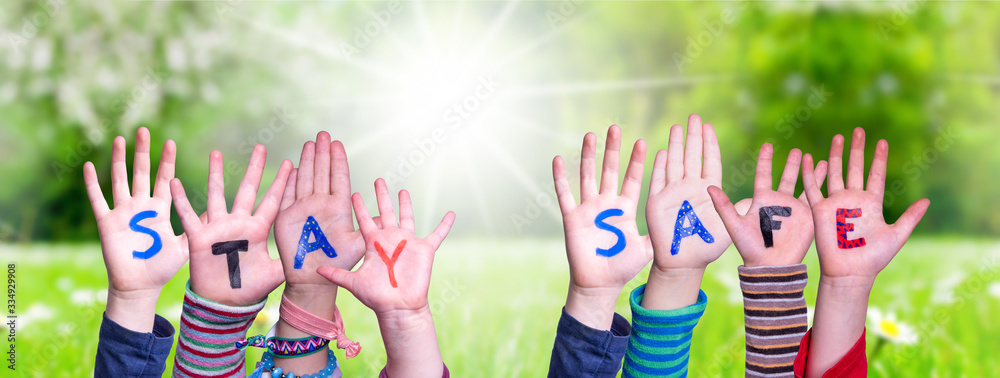 Kids Hands Holding Colorful English Word Stay Safe. Sunny Green Grass ...