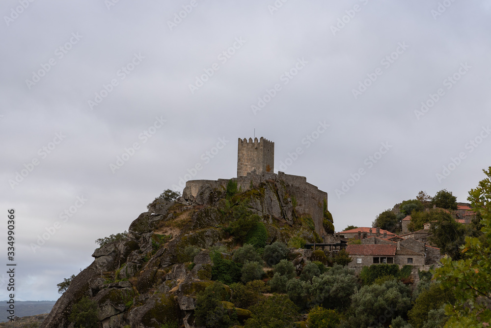Sortelha medieval castle on a very cloudy day. Sortelha is one of ...