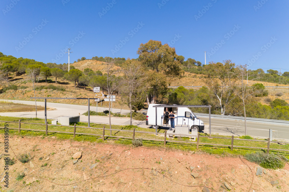 Couple living the van life inside camper van on a nature landscape ...