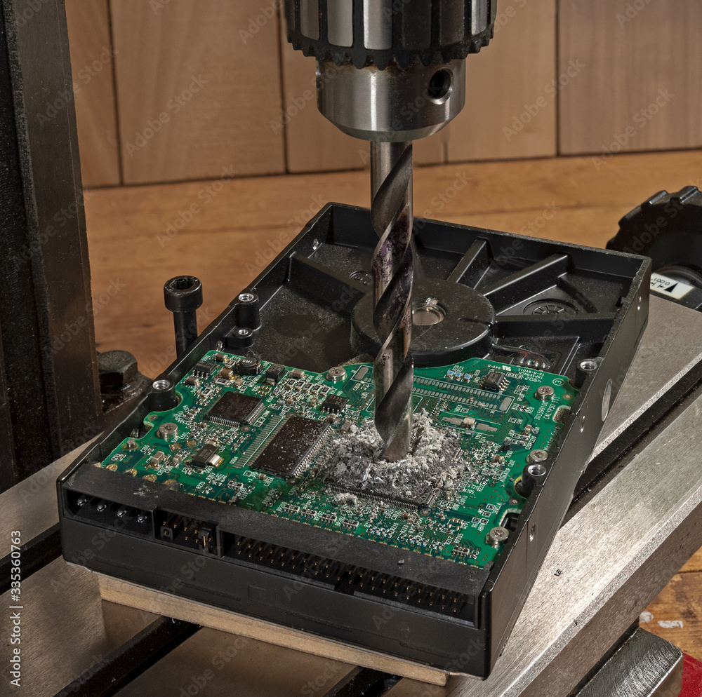 Foto de Stock Drilling a Hard Disk Drive to Destroy Evidence Data close ...
