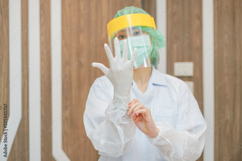 Front-line healthcare workers prepare wearing Personal Protective ...
