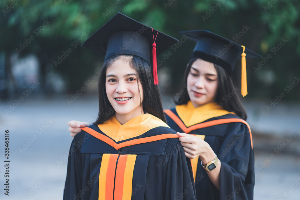 Young charming Asian feemale gradutes cerebrate her degree graduation ...