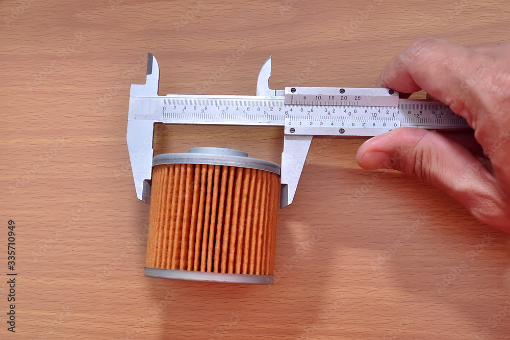 measure oil filter part use vernier caliper Stock Photo | Adobe Stock
