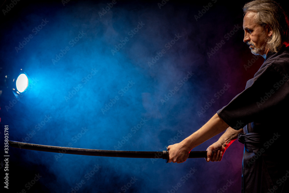 confident caucasian kendo warrior in traditional outfit use bamboo ...
