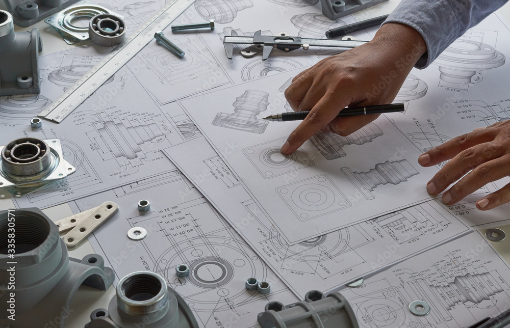 Engineer technician designing drawings mechanical parts engineering ...