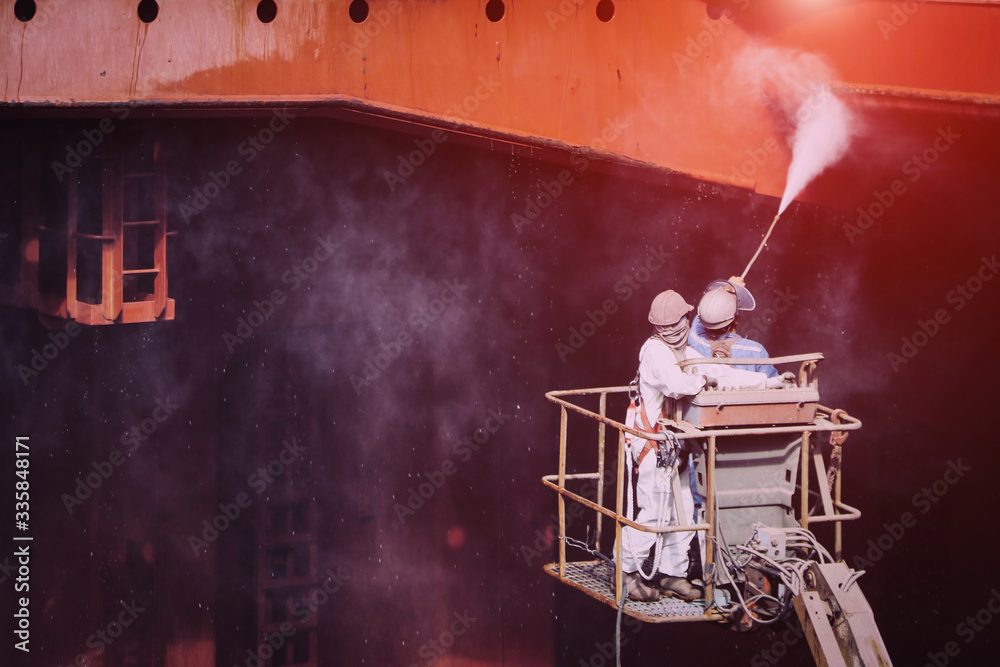 worker washing and cleaning in cargo hold of cargo ship in Shipyard on ...