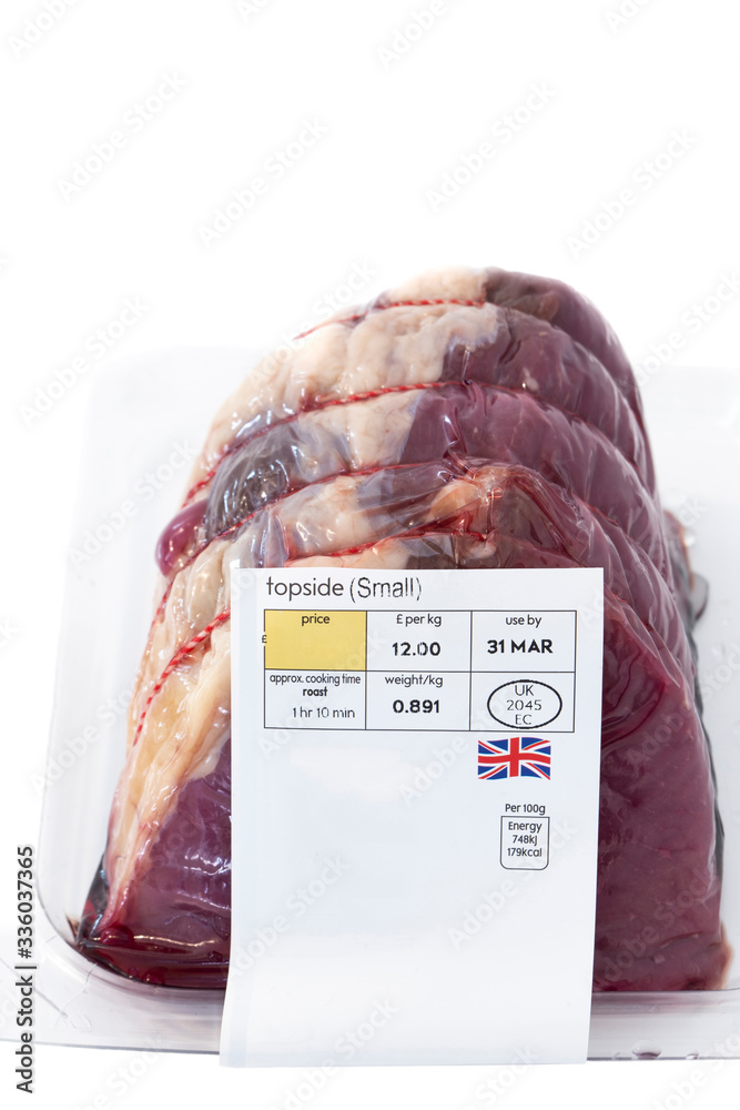 Raw topside of beef in plastic packaging with a food label sticker on ...