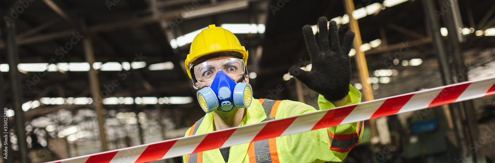 Man engineer wearing safety uniform with gloves and gas mask show hand ...