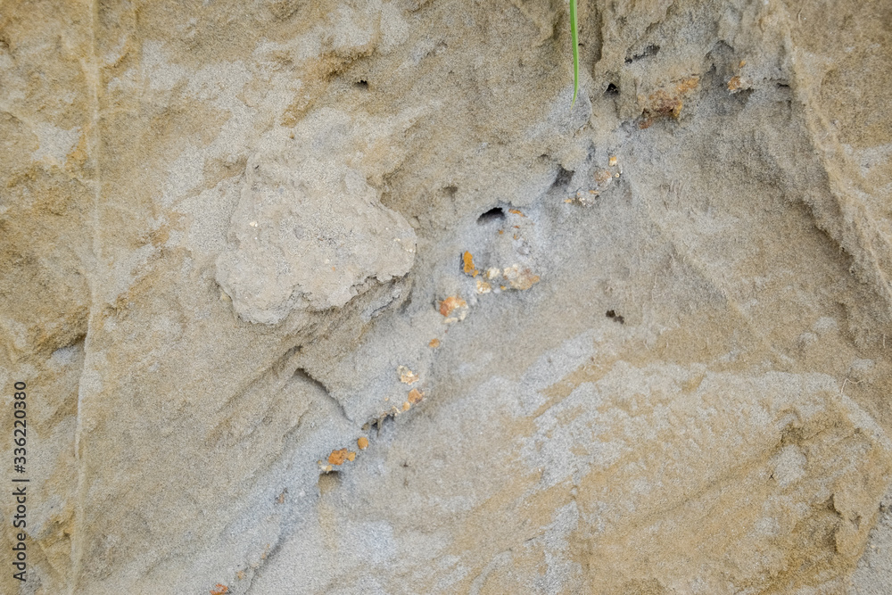 sedimentary layers of the rock in the sand scree. sand, pebbles and ...