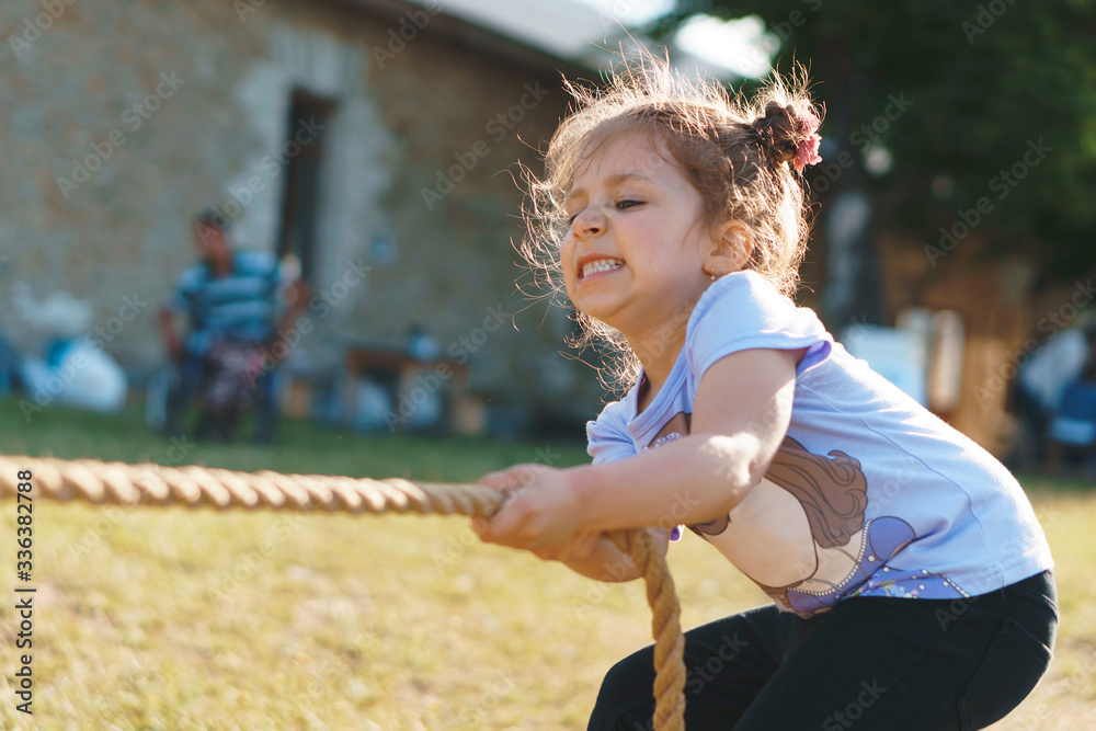 girl pulling rope with force Stock Photo | Adobe Stock