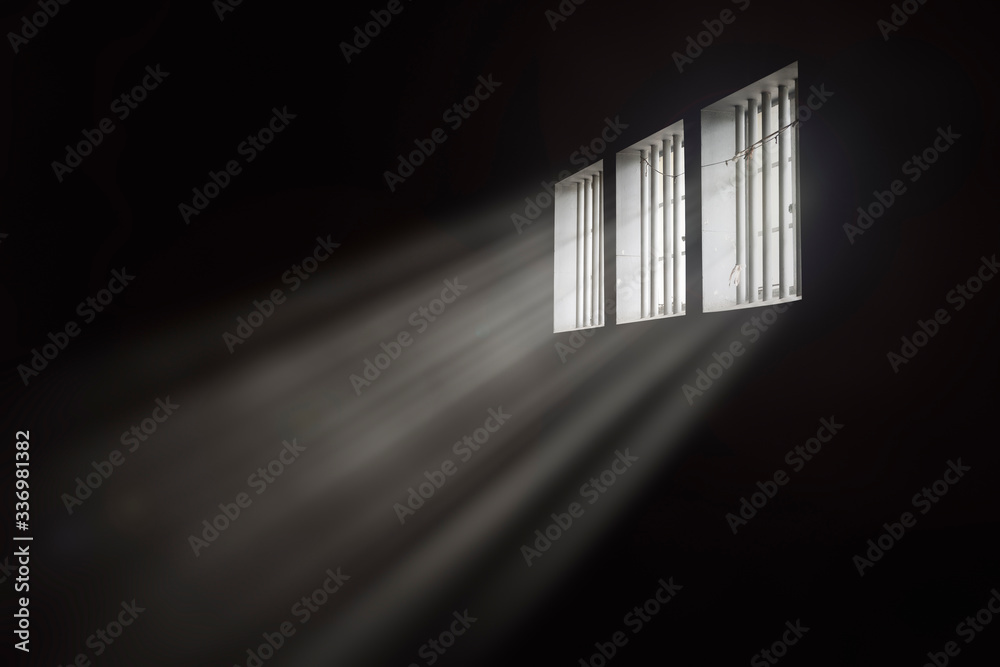 Beams of light through a barred prison cell window Stock Photo | Adobe ...