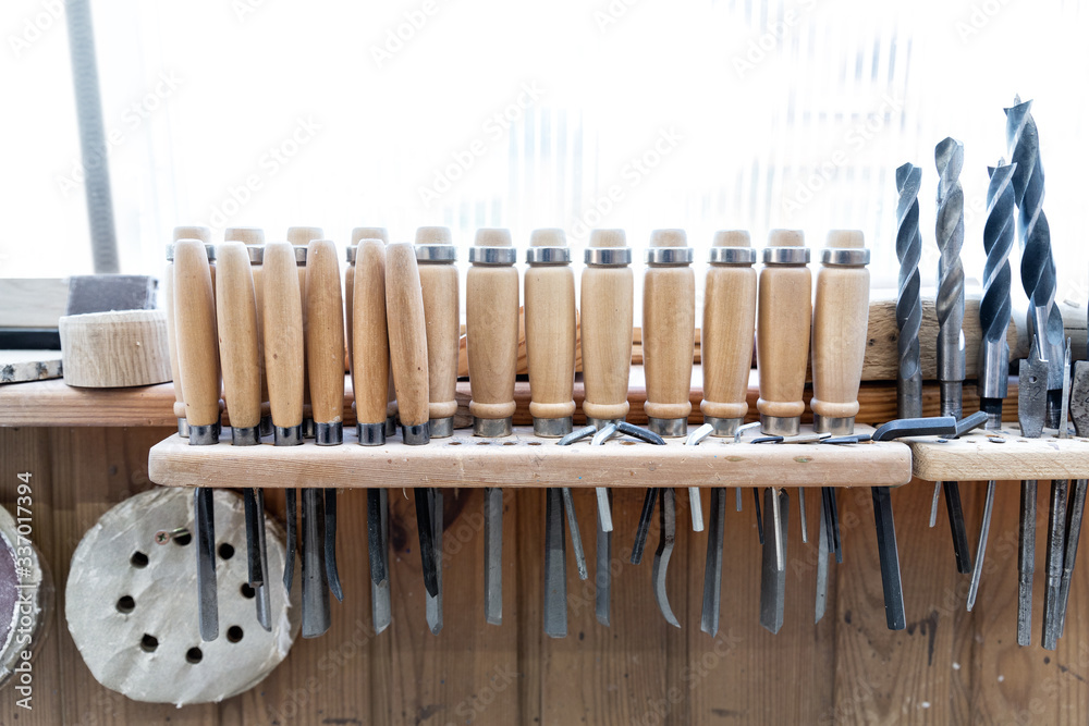 Set of woodworking tools and equipment hanged on wall at carpentry ...