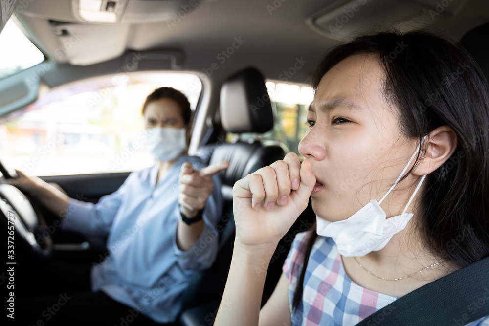 Sick child girl opened a protective mask while coughing,woman is spreading flu,cold,Covid-19 or ...