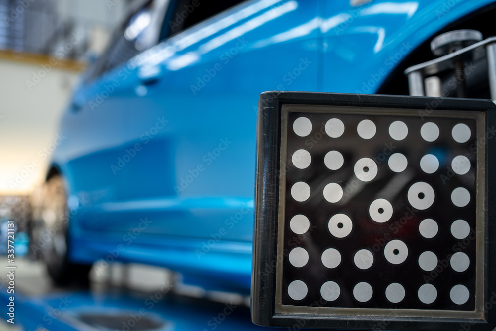 Pictures of wheel alignment Sensor mounted on mechanic during ...