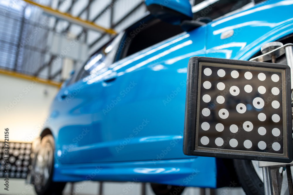 Pictures of wheel alignment Sensor mounted on mechanic during ...