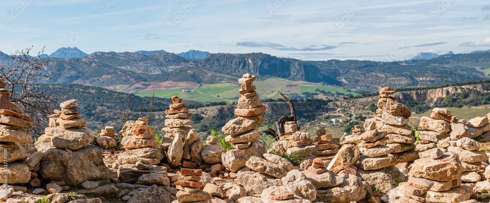 Piles of beautifully stacked stones near viewpoint of the Puente Nuevo ...