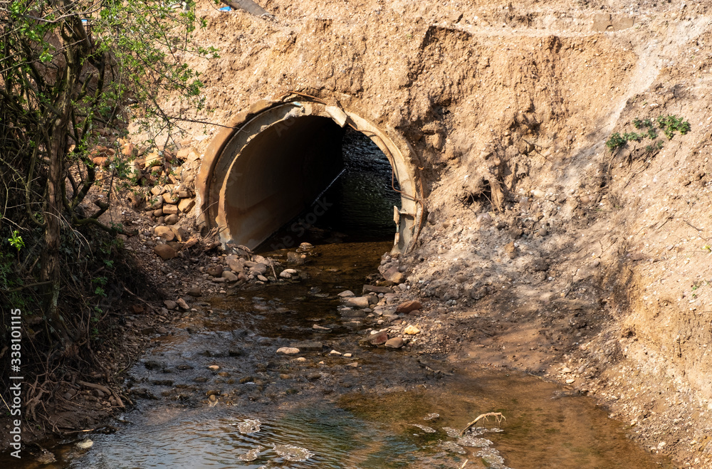 Outflow of water from a concrete drain pipe Stock Photo | Adobe Stock
