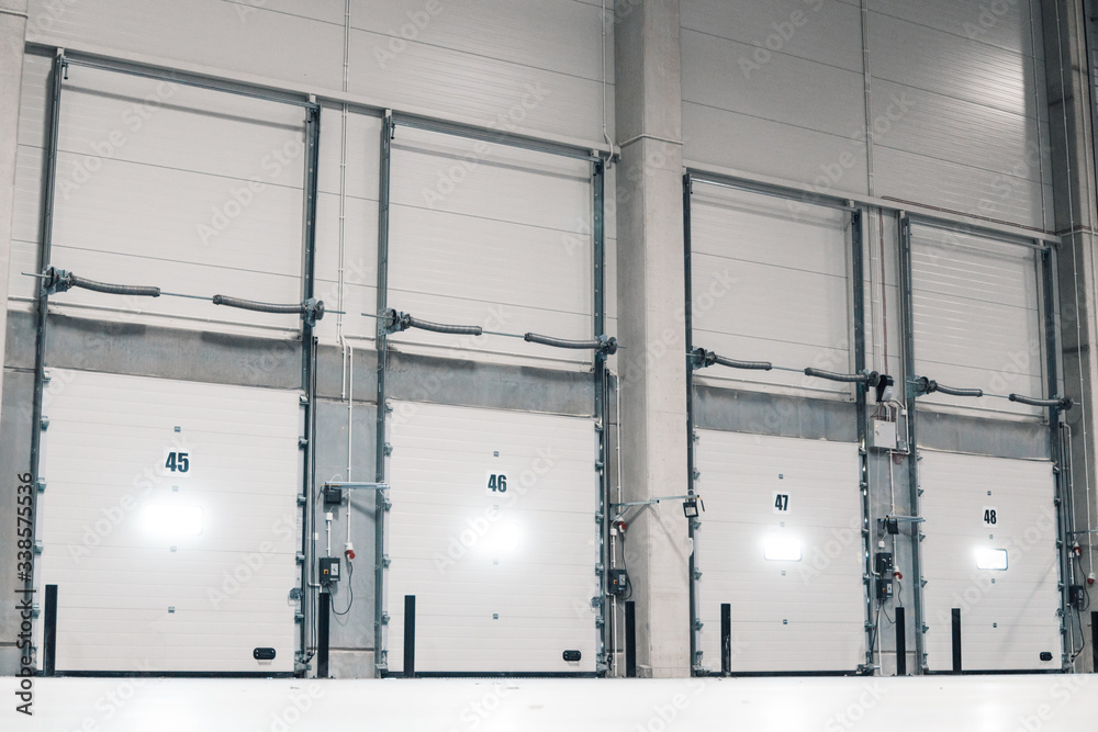 Three loading ramp doors at distribution warehouse from inside Stock ...